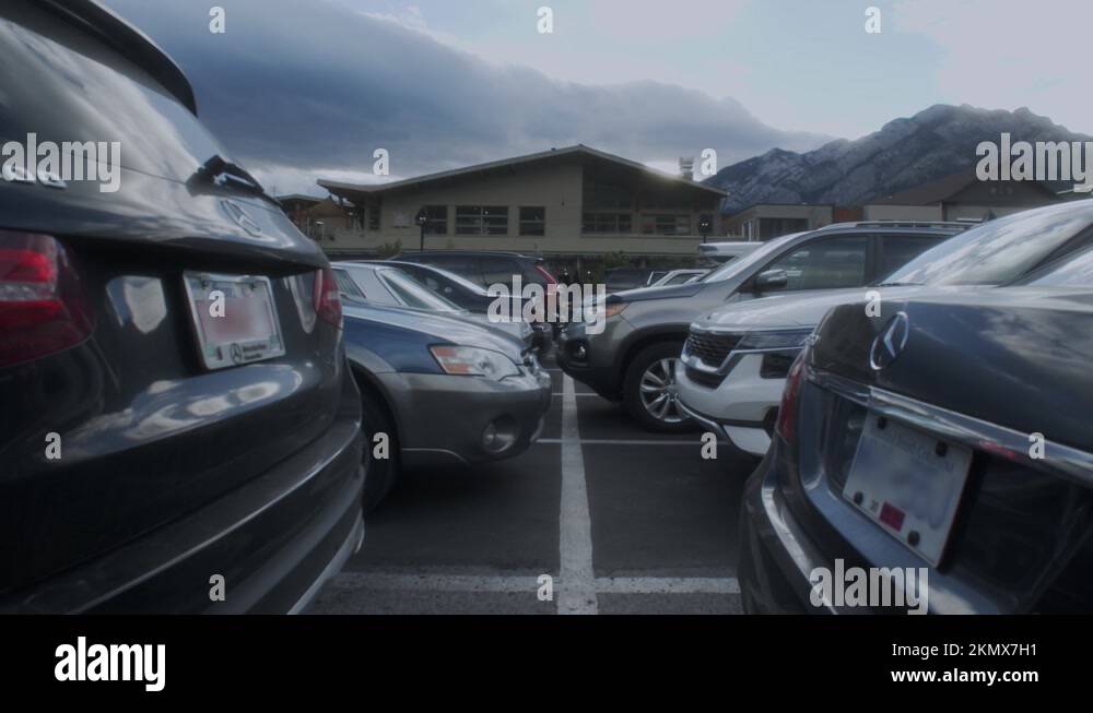 Parking lot view from between cars rising in downtown Stock Video ...