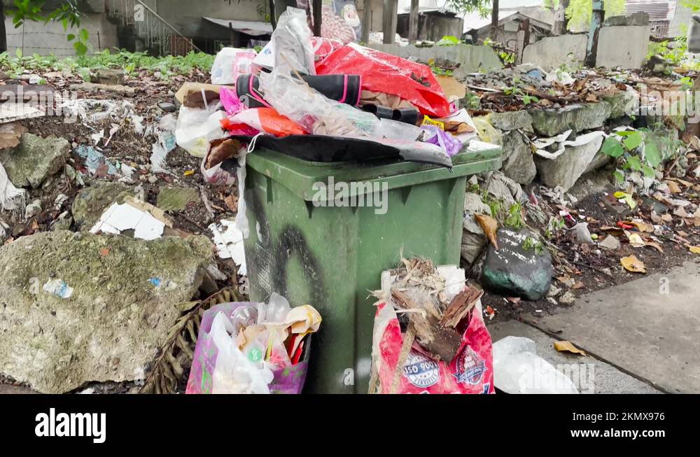 Uncollected pile of garbage and waste in a green garbage bin, 4k Stock ...