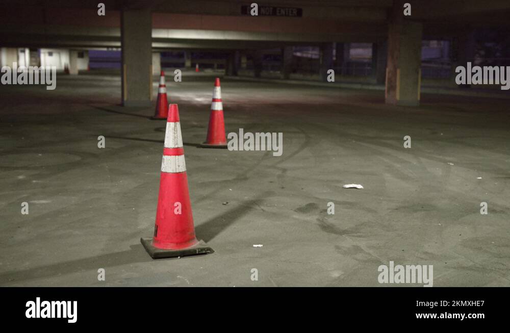 Orange Traffic Cones On The Floor Of Empty Parking Garage With Dirt And ...