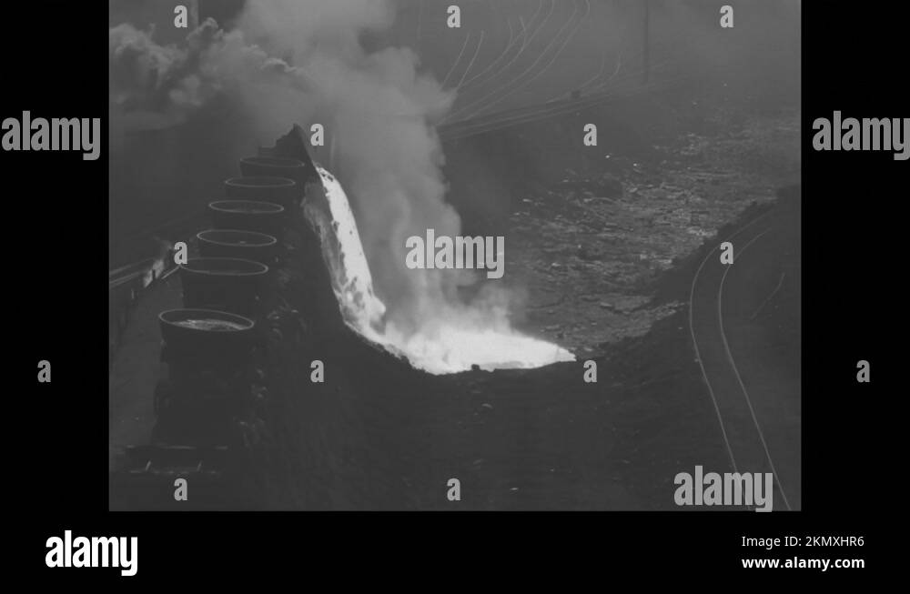 1950s: Bowls line edge of large ditch. Bowl pours molten liquid into ...