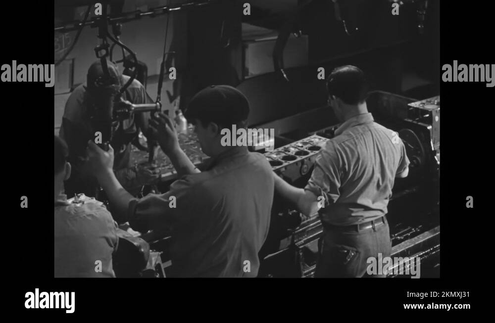 1950s: Interior automobile factory. Car motors on assembly line ...
