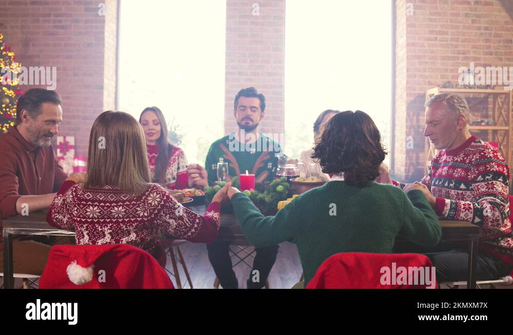 Relaxed calm family pray sit dinner table hold hands Stock Video ...