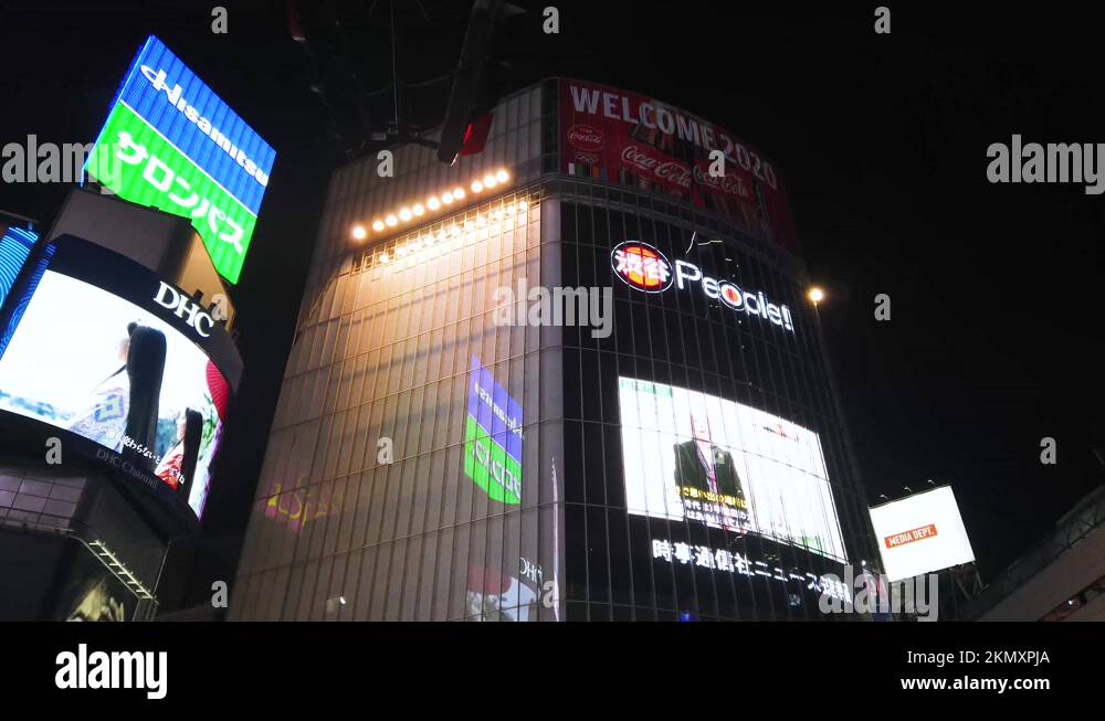 POV to many screen advertising billboard over building in shibuya area ...