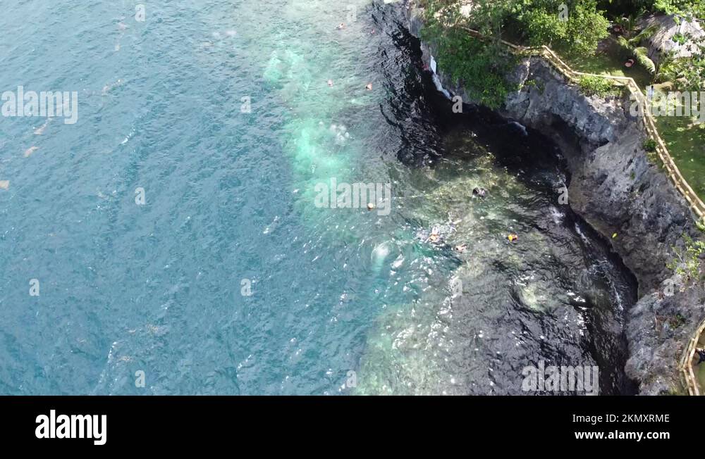 Bohol Island, Philippines, Aerial of people swimming with sardines in ...