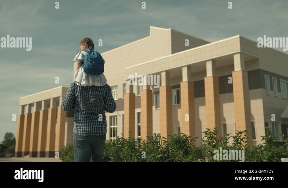A father carries a little daughter on his shoulders to school, a girl goes to Stock Video ...