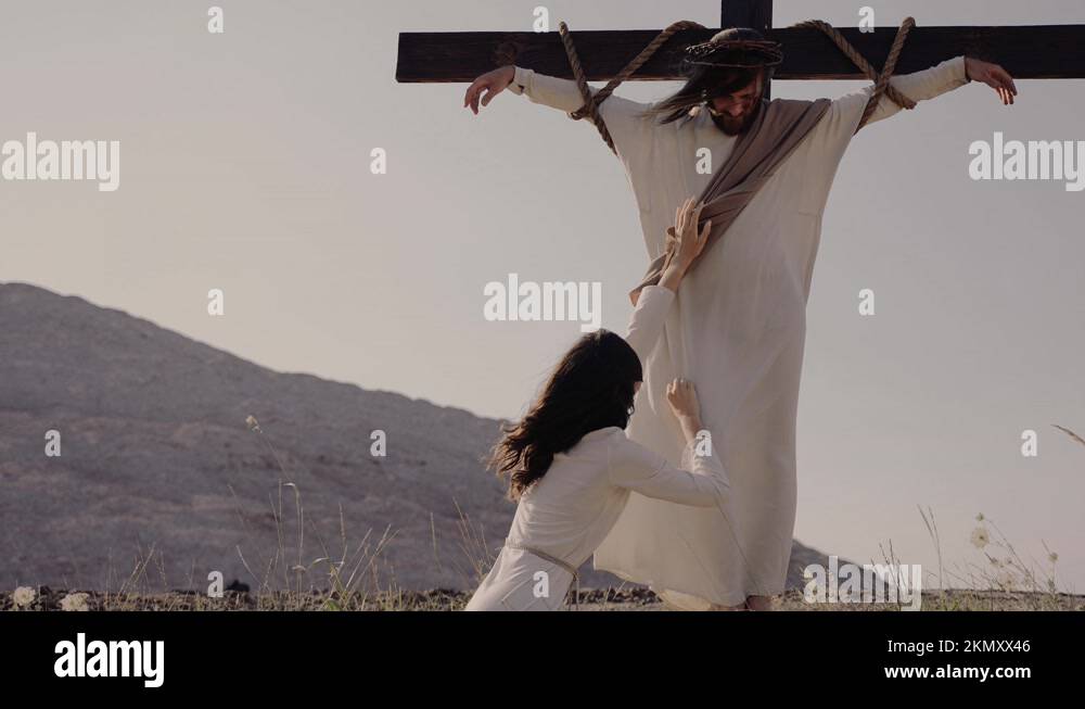 Mary mourns the death of Jesus at his feet. Jesus is crucified on the cross Stock Video Footage ...