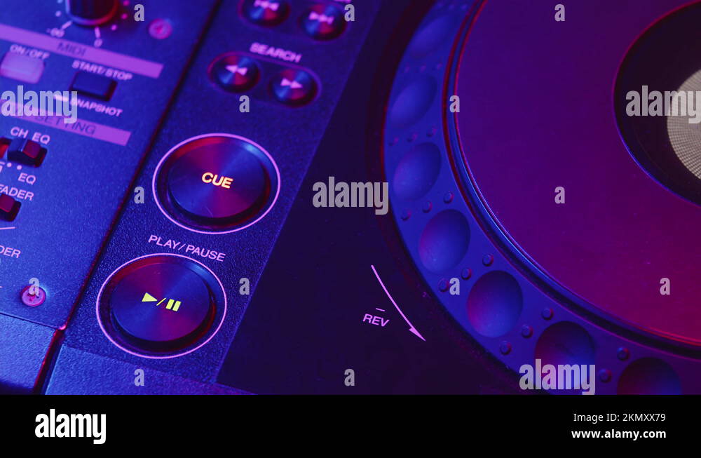 Male DJ's hand presses play button and rotates round platform on ...