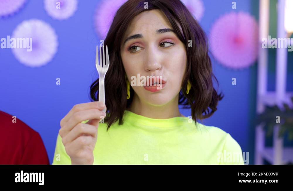 Sad girl shows a small fork. Young brunette woman is upset Stock Video ...