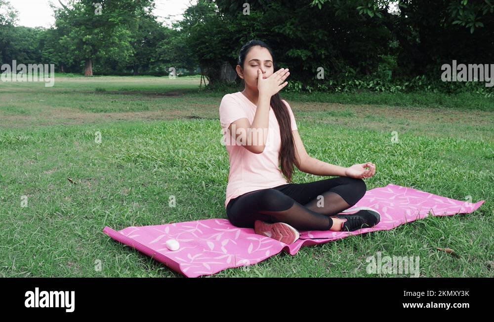 Teenage Young Indian girl doing Indian yoga Pranayam and meditation on Stock Video Footage - Alamy