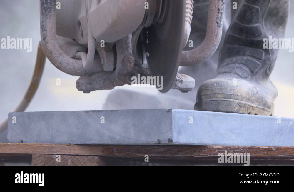Cutting paving stone slow motion circular saw power tool close up ...