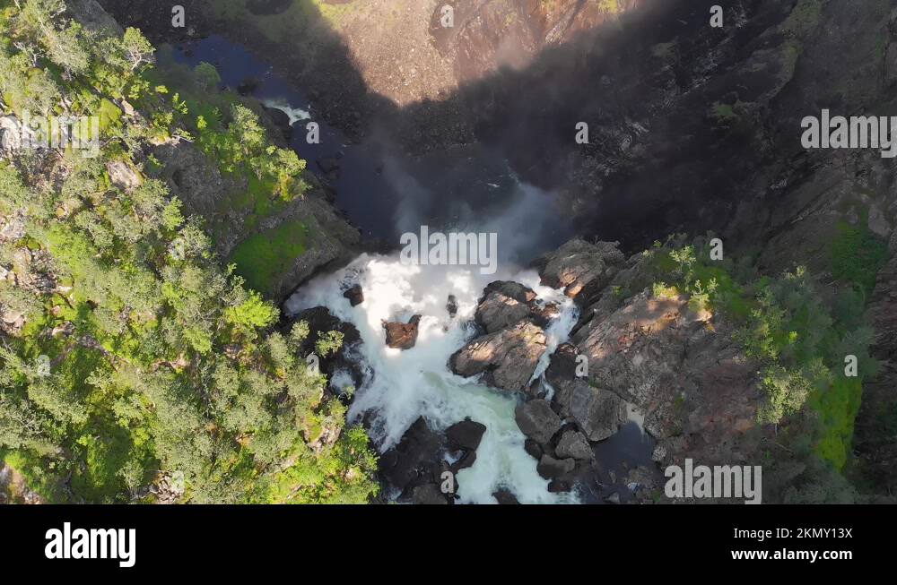 Voringsfossen waterfall from above, water plunging over edge to valley ...