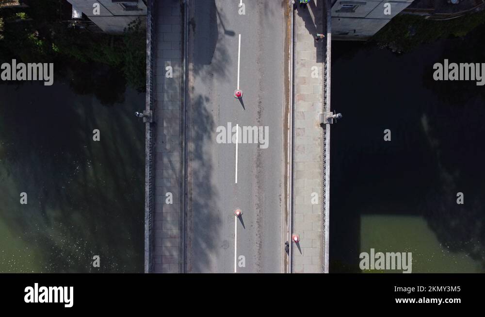 Top down of a historic road bridge over a river with traffic cones ...