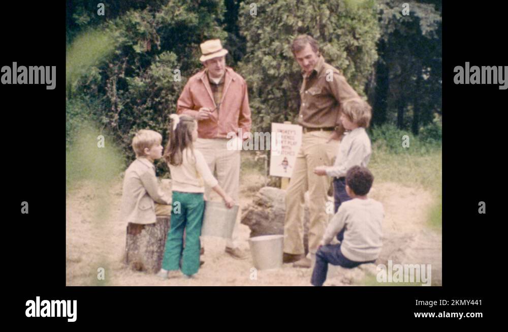 1970s: Gordon Jump listens. Children gather around Jump and Dennis ...