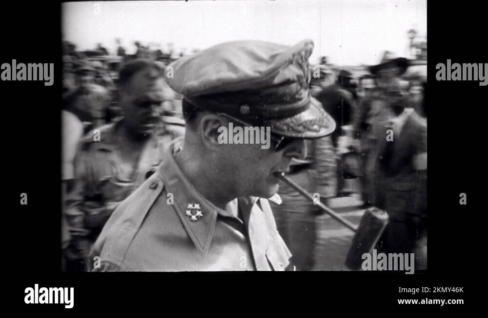 1940s: officer smoking pipe meeting people as he disembarks from plane ...