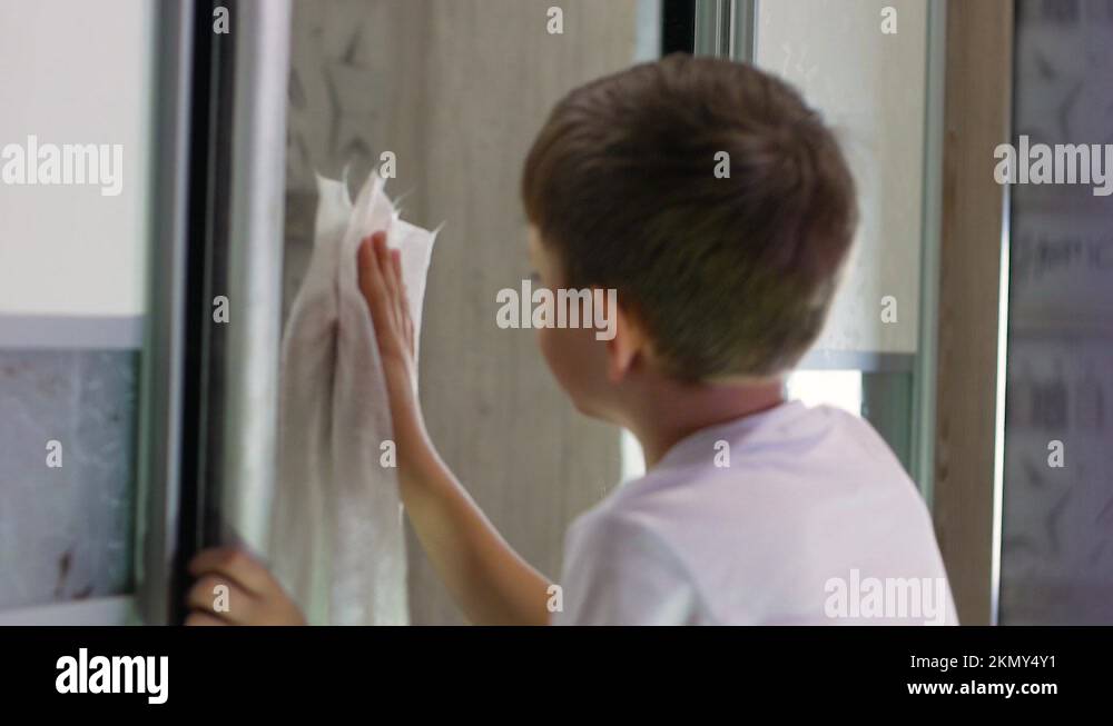 House cleaning in a good mood. The child cleans the dust from the ...