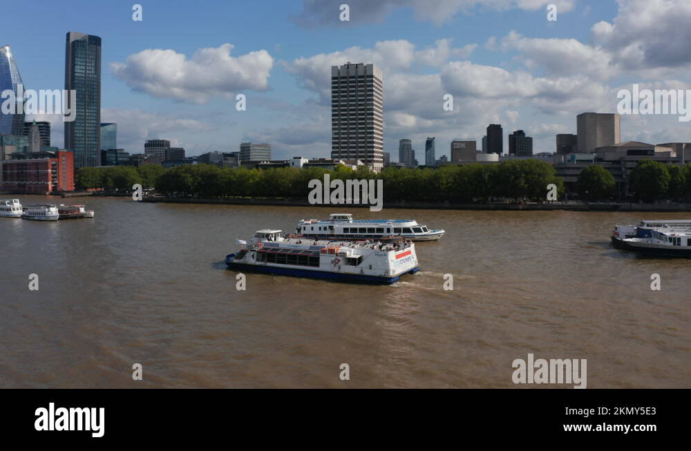 Tracking shot of cruise ship floating on wide water surface of River ...