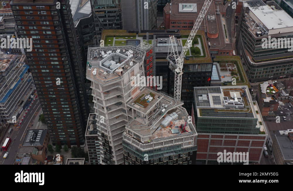 Fly above construction site of new modern tall office or residential building in Stock Video ...