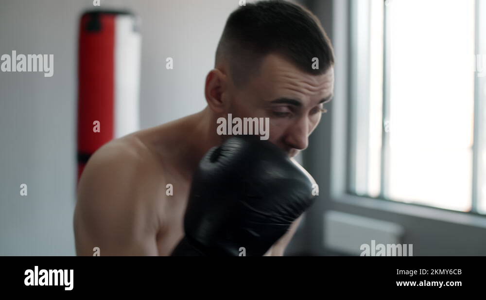 Close up shadowboxing in slow motion, kickboxer is fighting with shadow ...