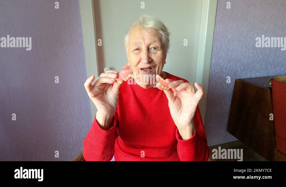 dental-concept-elderly-female-85-years-old-inserts-denture-stock-video