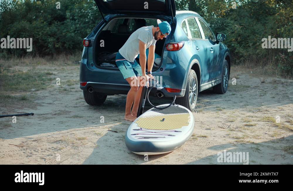 Man Inflates Standup Puddle Board.Sup Board Inflate.Surfing On Sup ...