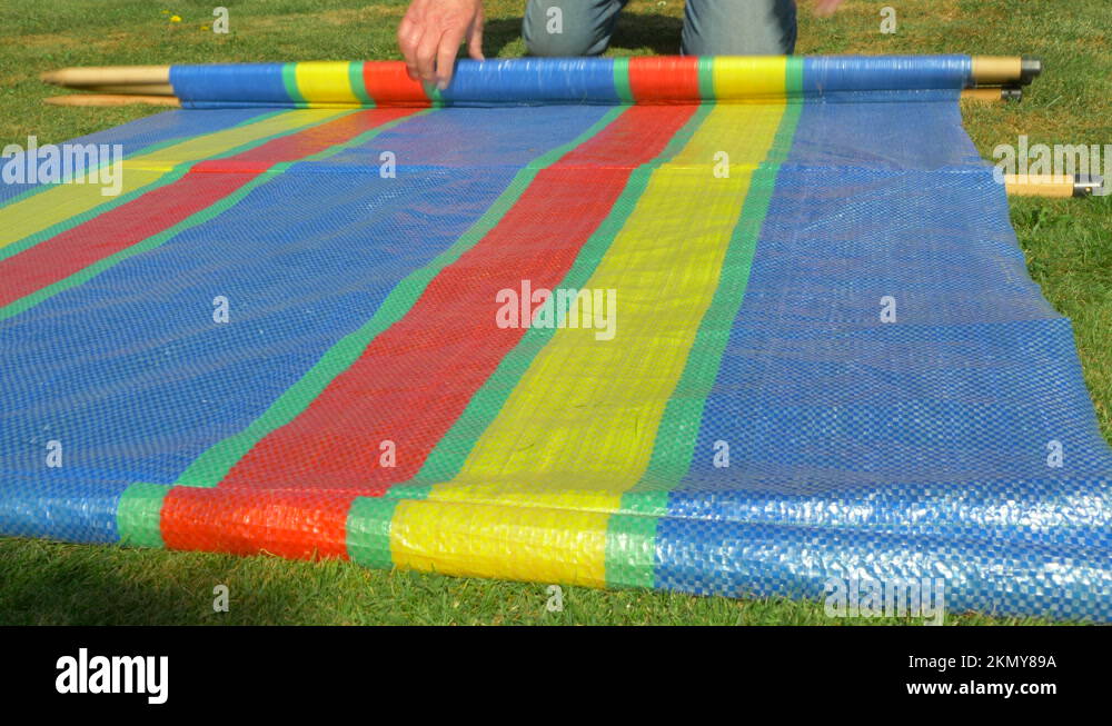 Man unrolling a camping wind break / screen on grass Stock Video ...