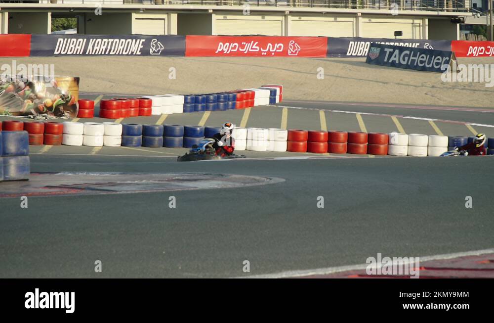 Dubai kart drome slow motion karting over kerbs with hands up waving ...