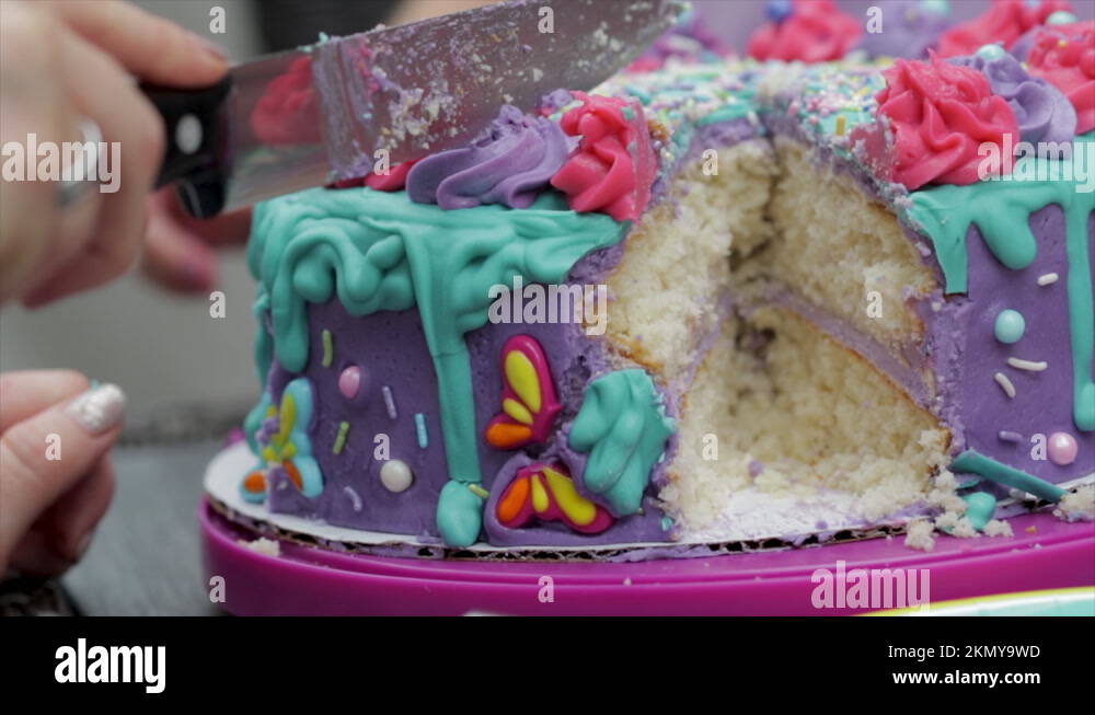 Birthday cake slice of birthday cake. Knife cutting into a pastel ...