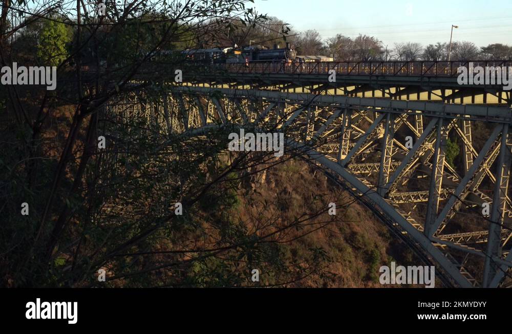 steam train crosses the Victoria Falls Bridge, Zimbabwe Zambia border ...