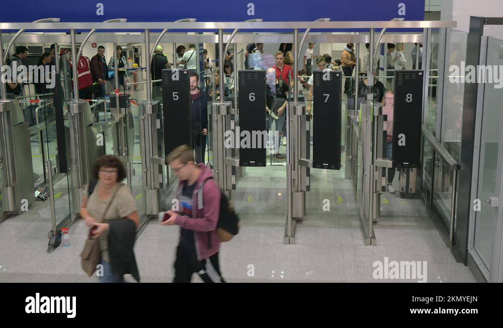 Passengers pass through automated passport control gates. Timelapse ...