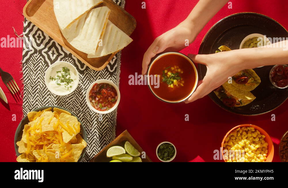 Mexican food on table. Traditional tex mex cuisine. Putting tomato soup ...