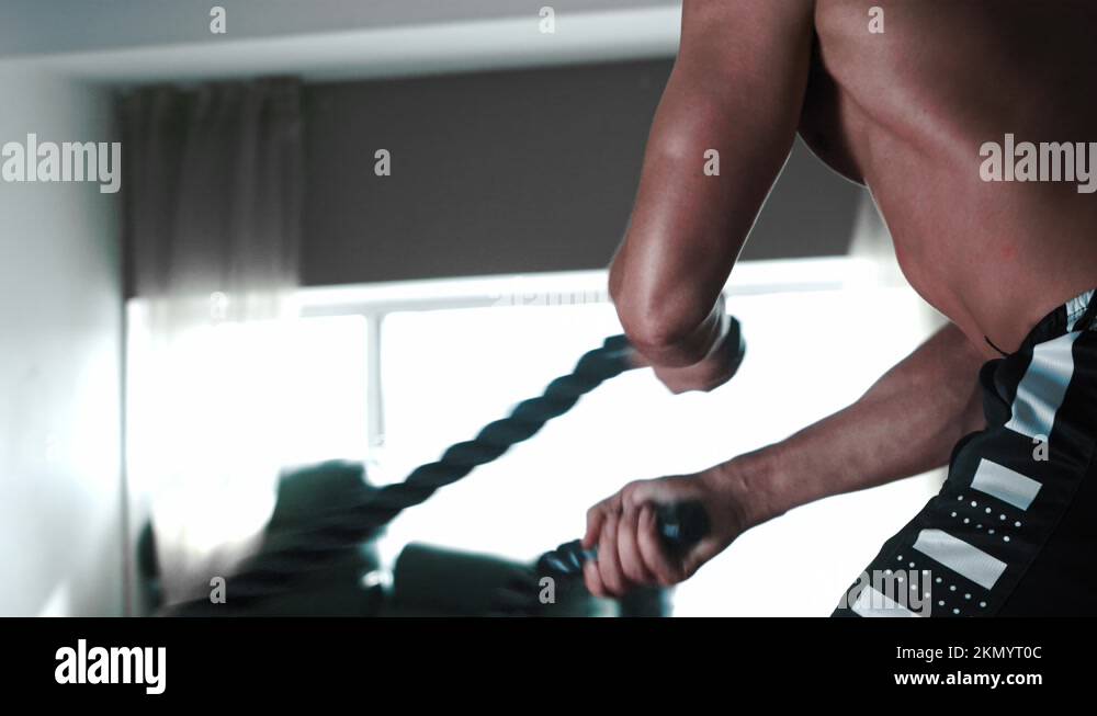 Crossfit training - shirtless young man doing an endurance exercise ...