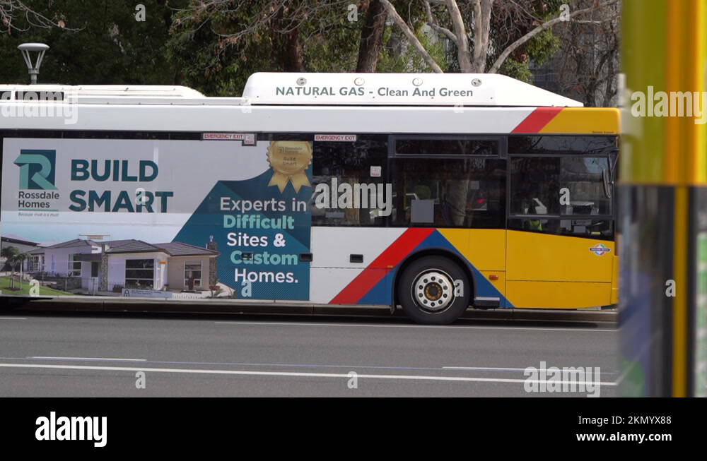 Public transport bus with passengers and advertisement on side, dolly ...
