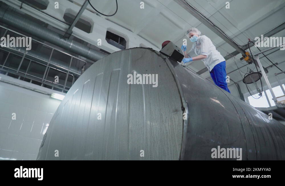 Worker Mixing Milk On Top Of Metal Tank For Quality Test At Laboratory ...