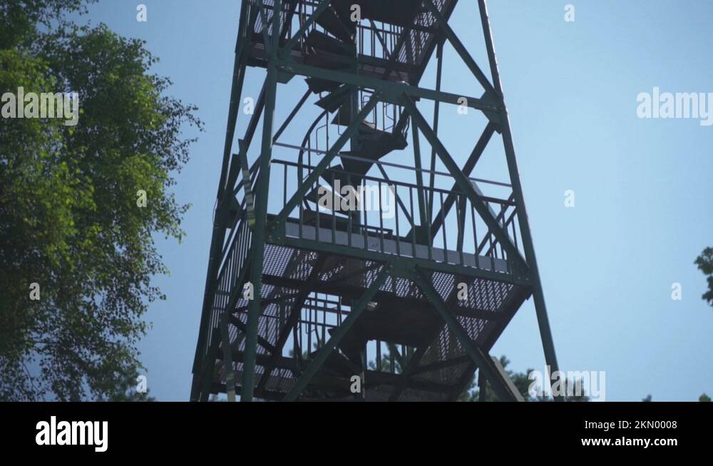 Revealing shot of a tall observation tower at Kalmthoutse Heid in ...