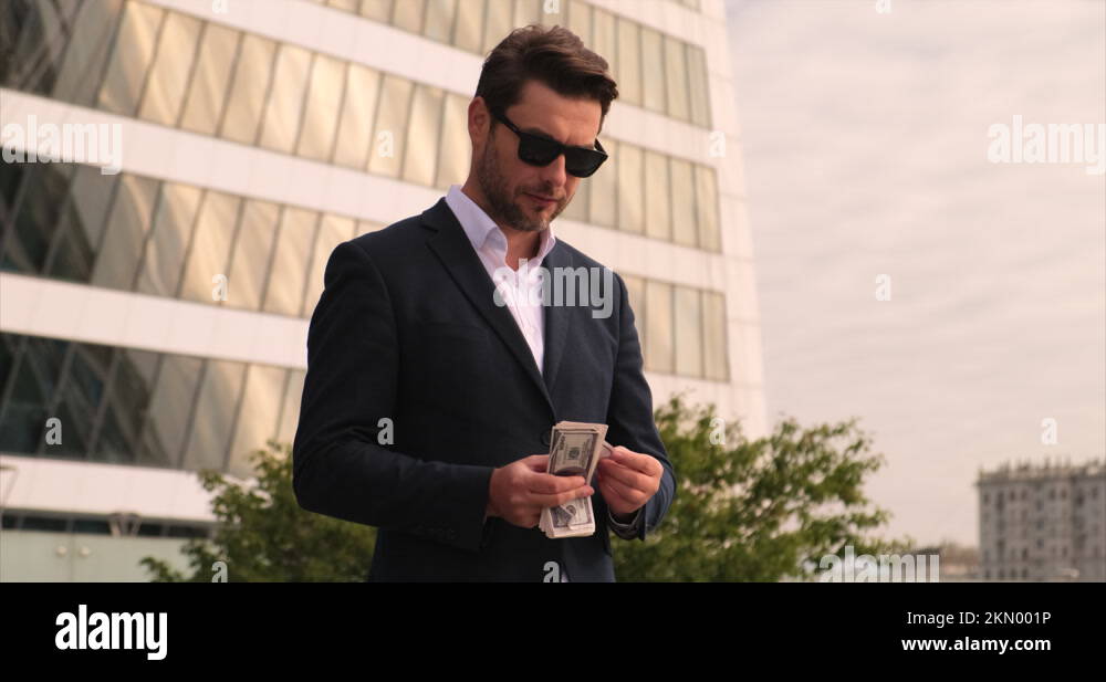 man counts money in his hands. Accounting the power of money, wall ...