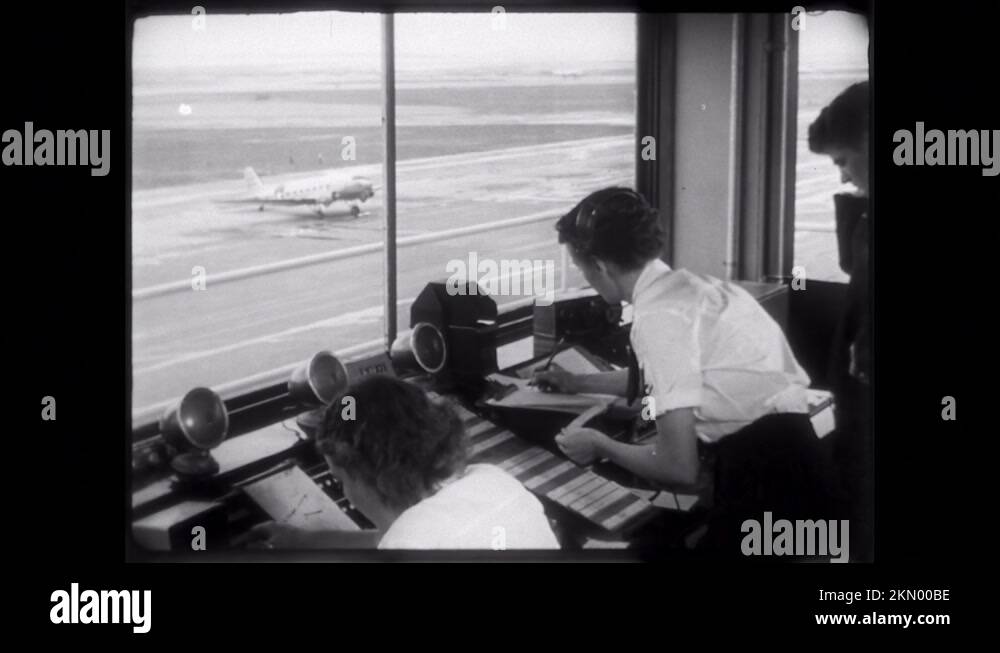 1950s: Pilots in cockpit of airplane. People in air traffic control ...