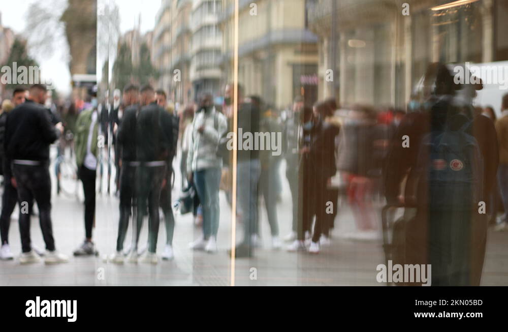 Crowd in street walking and shopping on glass reflection, blurred city ...