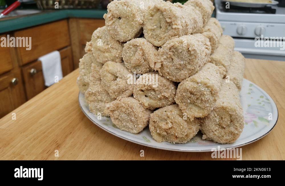 Panning left to right of pile of croquettes in plate ready to be cooked ...