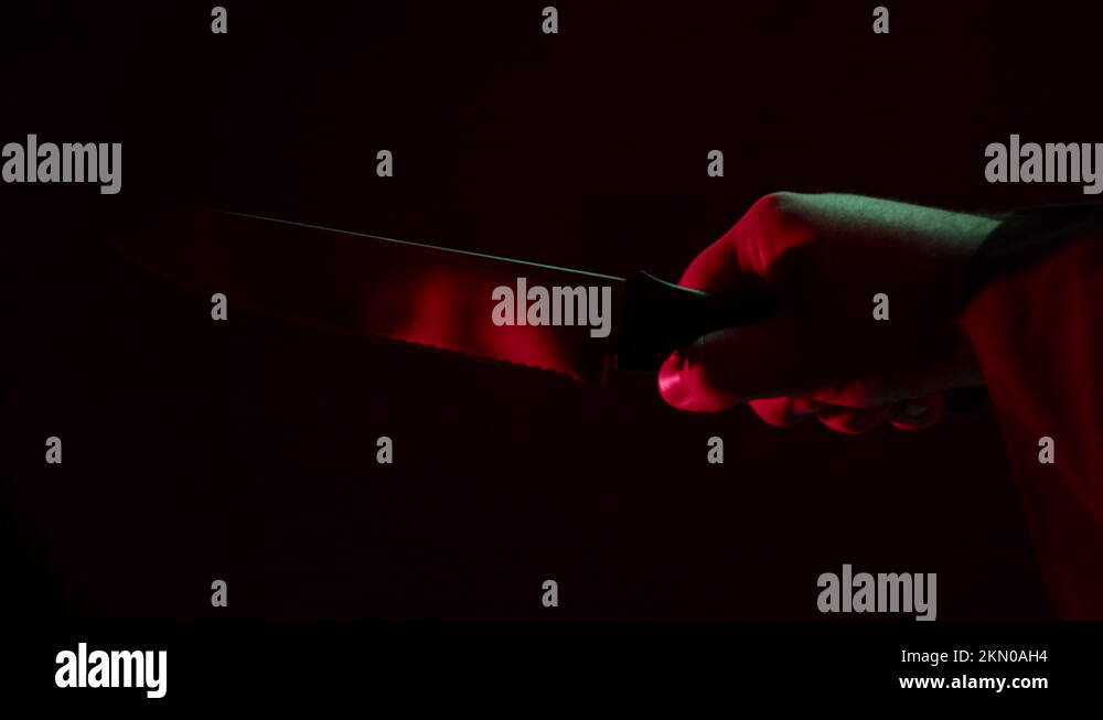 Reflection of evil killer in knife close-up. Psycho murderer hand ...
