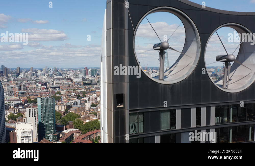 Ascending footage of Strata skyscraper with wind turbines on top ...