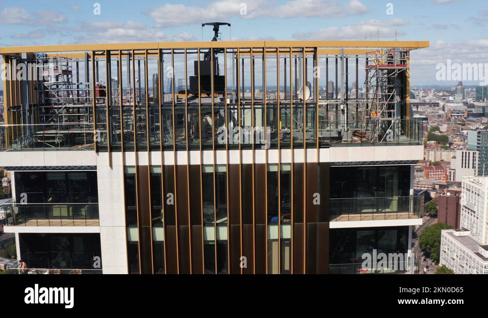 Orbit shot around top of One The Elephant skyscraper. Scaffolding and ...