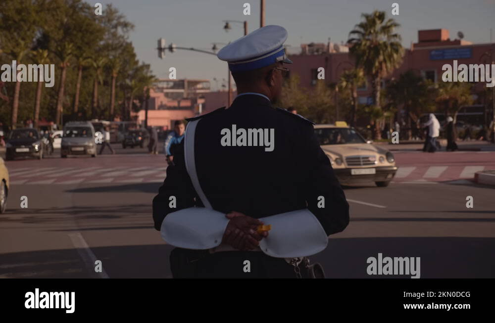 Moroccan police officer standing guard on busy intersection Stock Video ...