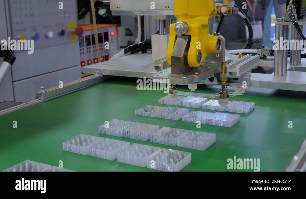 Pick and place robotic arm manipulator moving plastic detail on ...