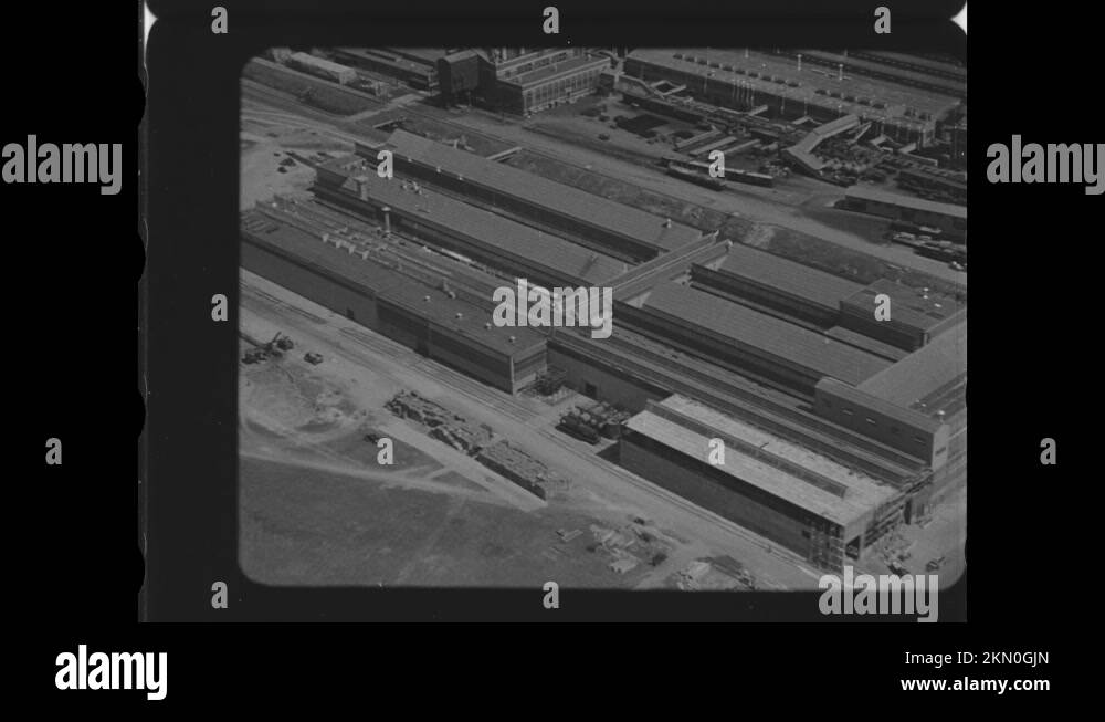 1920s: Looking down on factory buildings on large complex from sky ...