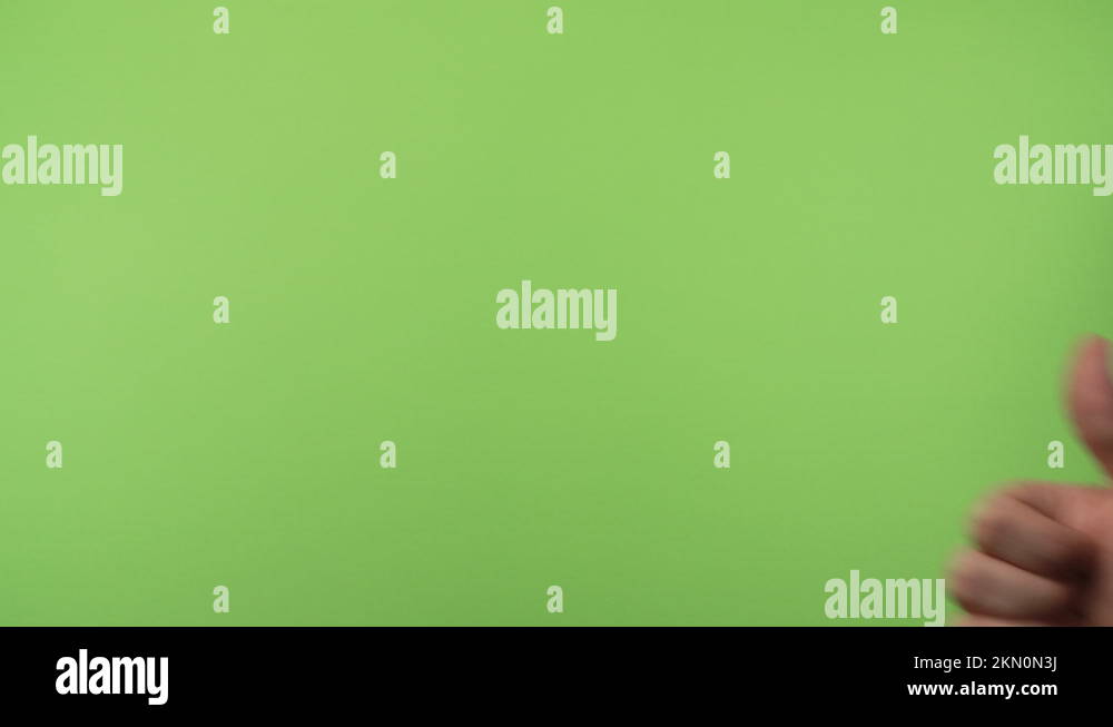 adult hand white man showing thumbs up in front of chroma green screen ...