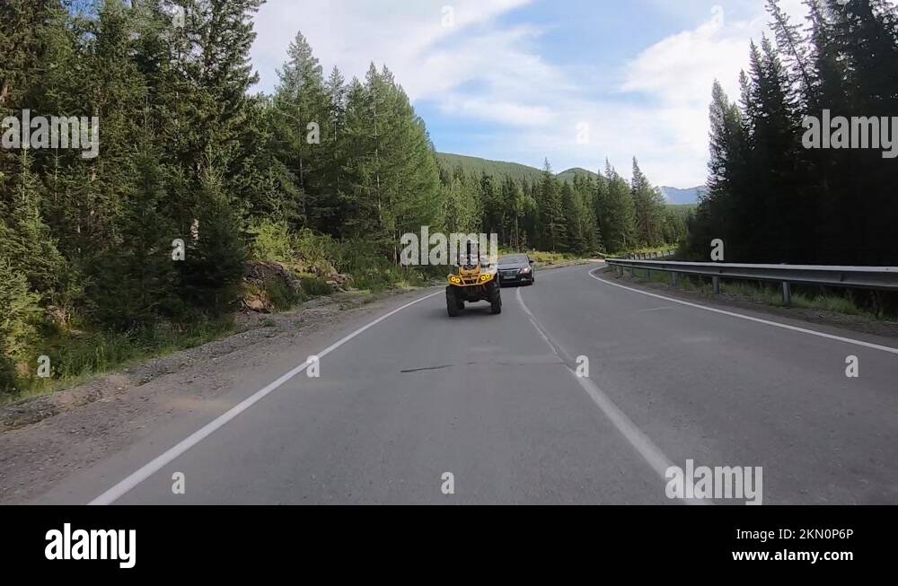 The ATV is driving fast on a flat asphalt road. Front view Stock Video ...