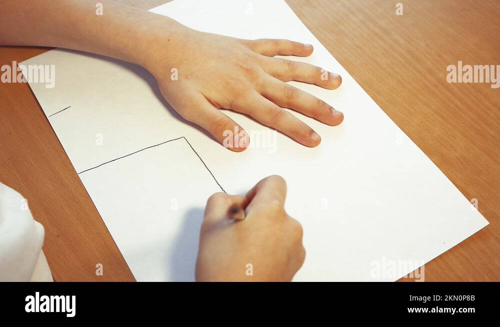 Children's hands draw the outline of the house with a pencil Stock ...