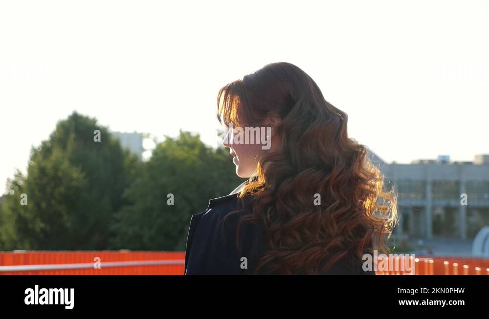 Lady with copper hair walks turning back along footbridge Stock Video ...