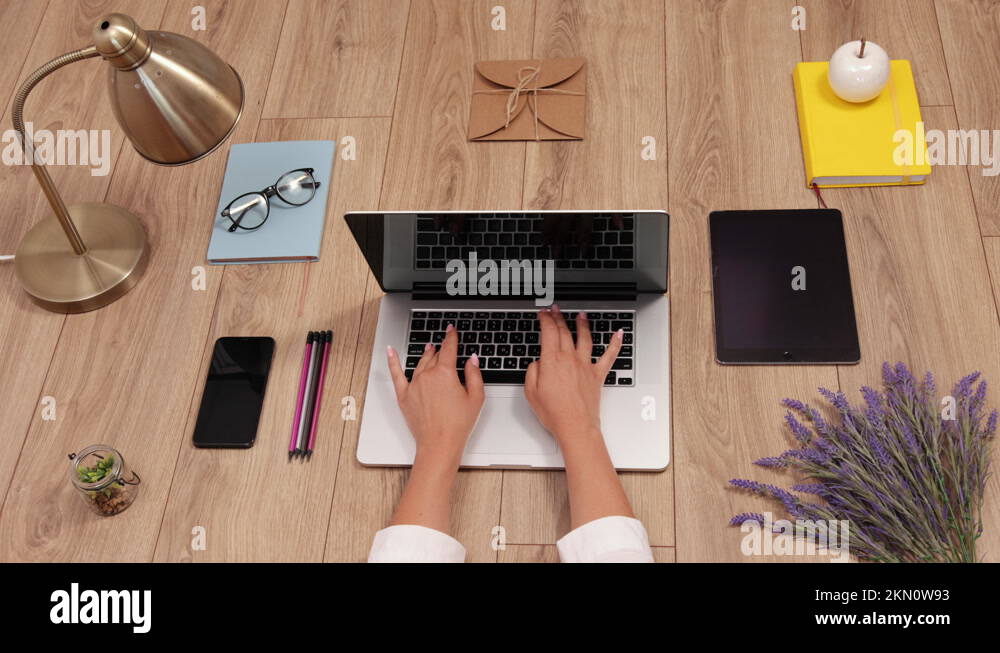 Types text on keyboard on craft background laptop notebook flat lay ...