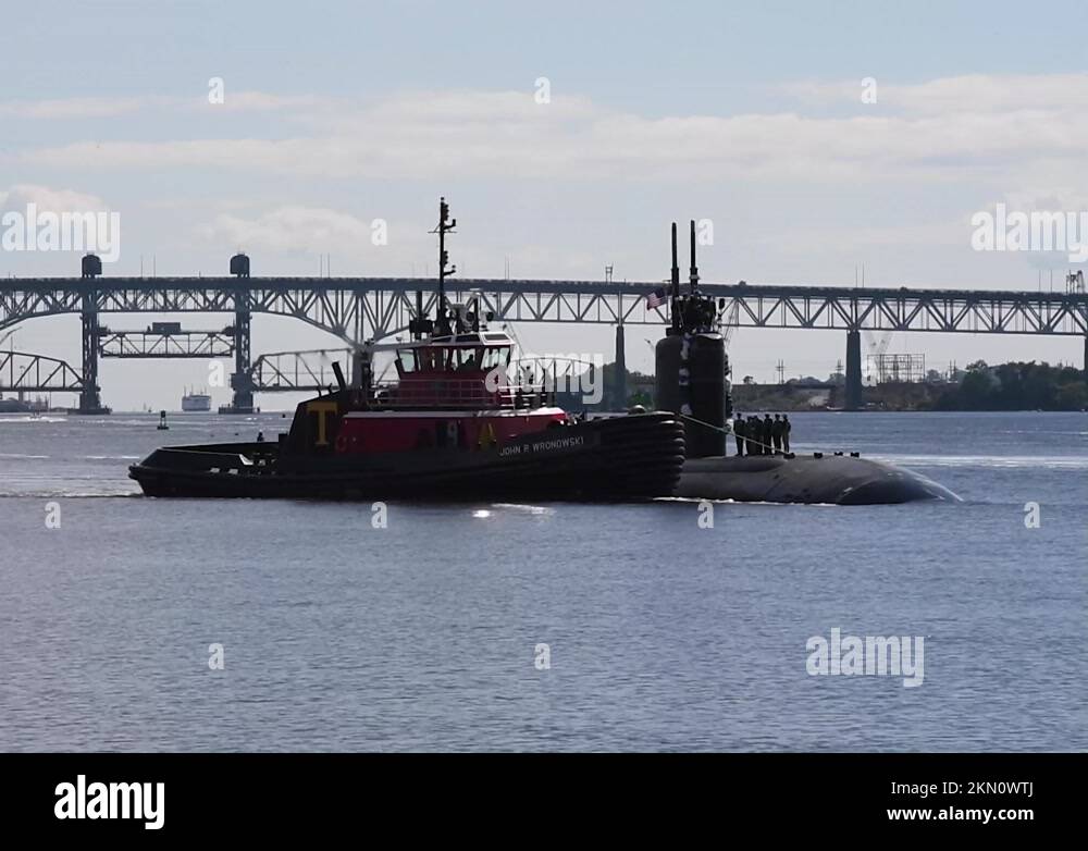 Tug boat guiding U.S. Navy submarine USS Montpelier into Naval ...